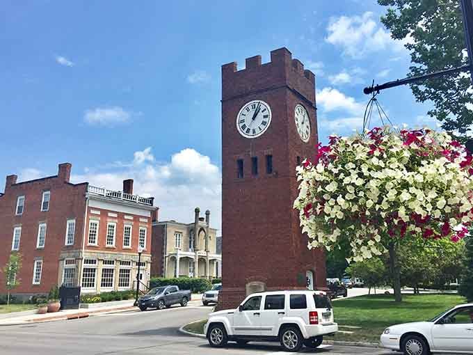Cascading flowers frame the clock tower like nature's own picture frame highlighting small-town American beauty at its finest.