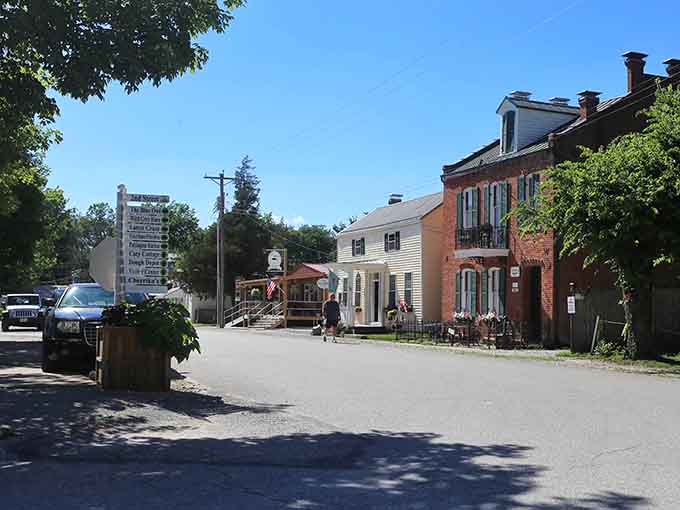 Brick buildings and leafy trees shade a quiet street where the biggest decision is which antique shop to explore first today.
