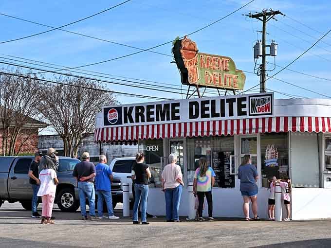 That vintage neon cone and candy-striped awning scream classic Americana louder than a jukebox playing Elvis hits.