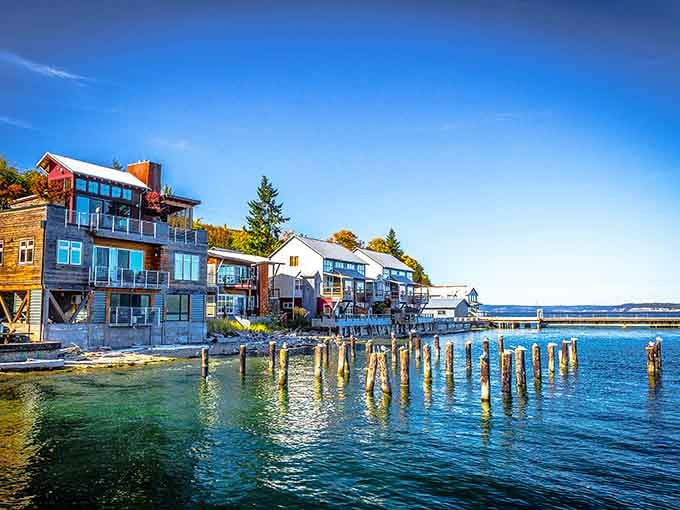 Weathered pilings stand guard like retired sailors telling stories to these colorful waterfront homes.