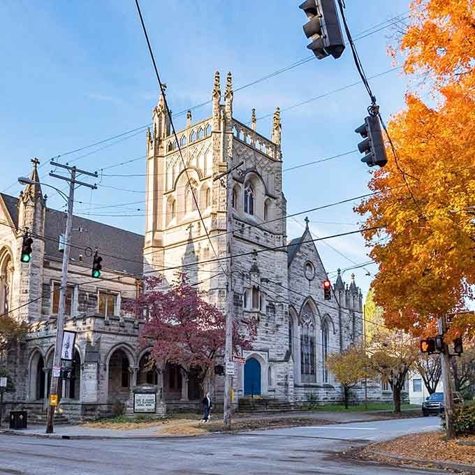 Gothic stone architecture framed by autumn's blazing colors creates a scene worthy of any postcard collection you've got.