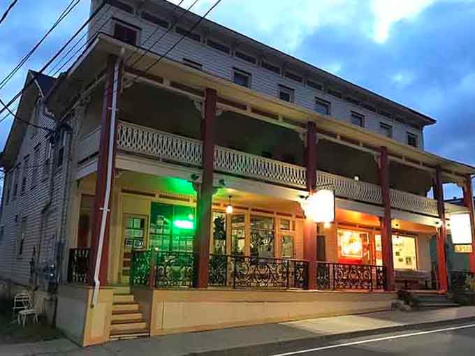 The ornate balcony railings and vintage architecture hint at stories this building could tell from decades of feeding travelers.