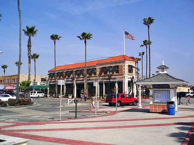 Classic Spanish Colonial architecture meets beachside living where the flag waves proudly over sun-soaked streets below.
