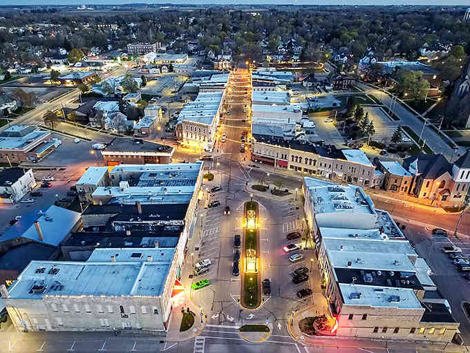 Downtown lights twinkle at dusk like stars descended to earth, illuminating streets where community thrives and small-town magic happens nightly.