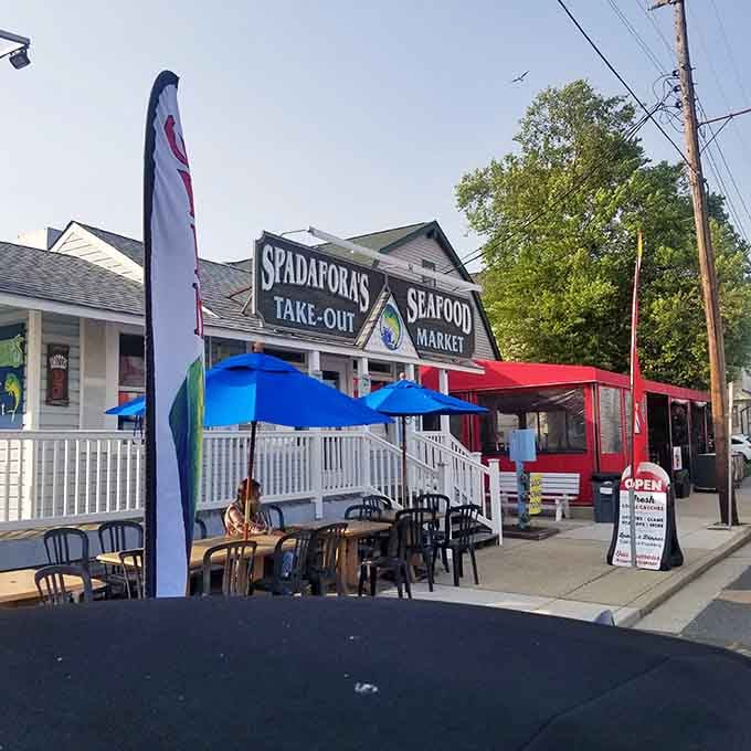 Colorful umbrellas and white picket fencing create a cheerful outdoor oasis for enjoying the freshest local catches available.