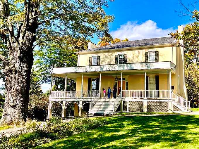 That elegant yellow facade and wraparound porch whisper stories of American art history where the Hudson River School was born and flourished.
