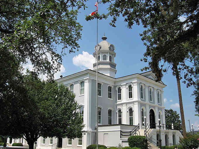 This pristine white courthouse with its clock tower represents small-town Southern architecture at its most dignified and photogenic.