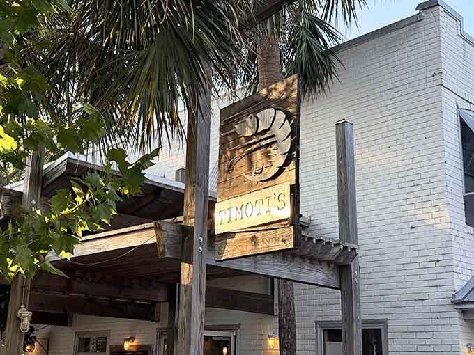 That hand-carved wooden sign surrounded by palms whispers "authentic" louder than any fancy advertising campaign could.