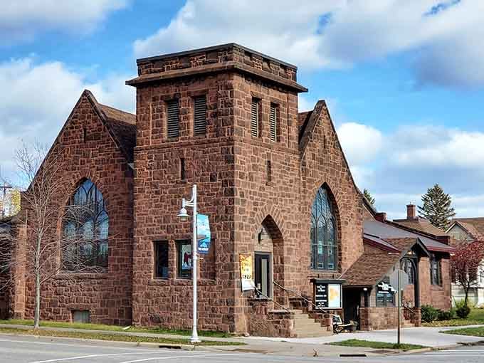 This stunning brownstone church shows how communities built things to last, with Gothic windows reaching toward endless blue skies.
