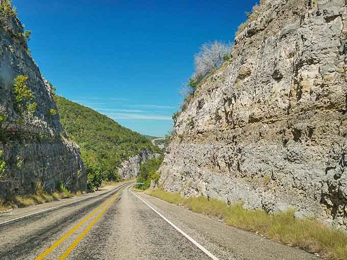 Towering limestone walls embrace the road like nature's cathedral, humbling and magnificent in equal measure.