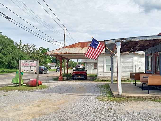 The American flag waves proudly over weathered buildings that have served the community for countless years.