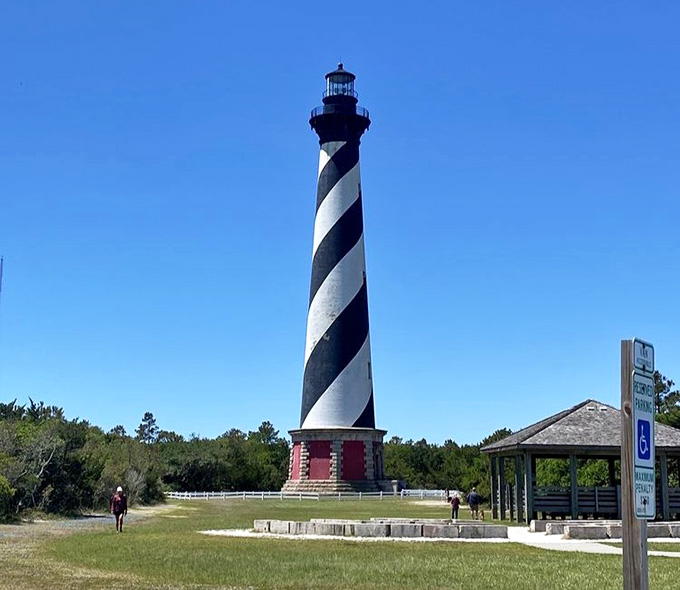 Standing tall against endless blue sky, this lighthouse remains the ultimate symbol of coastal strength and guidance.