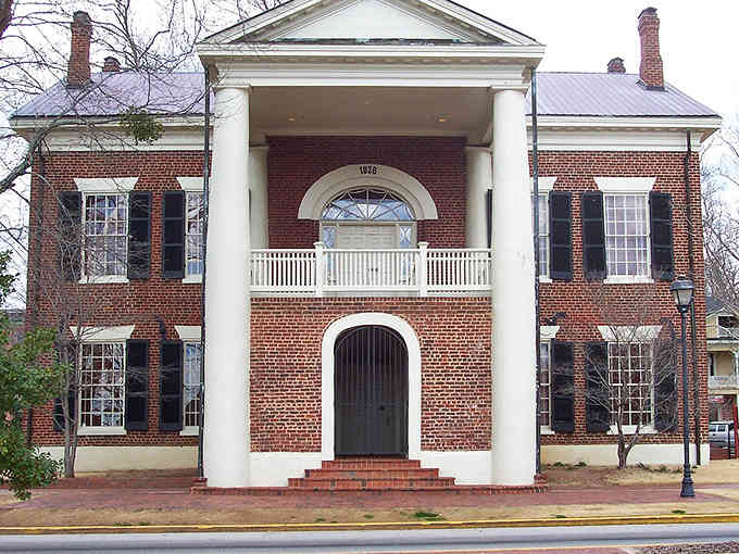 Those columns mean business! This two-story brick beauty is as grand and dignified as a classic Hollywood leading man.