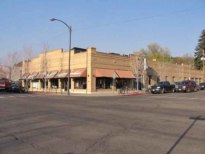 That ornate stone bank building anchors quiet streets where history whispers from every carefully preserved architectural detail.