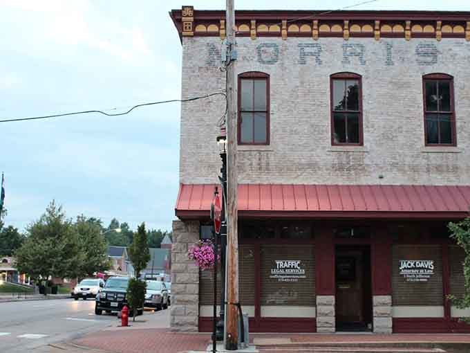Faded ghost signs on weathered brick tell stories of businesses past, like whispers from another era.