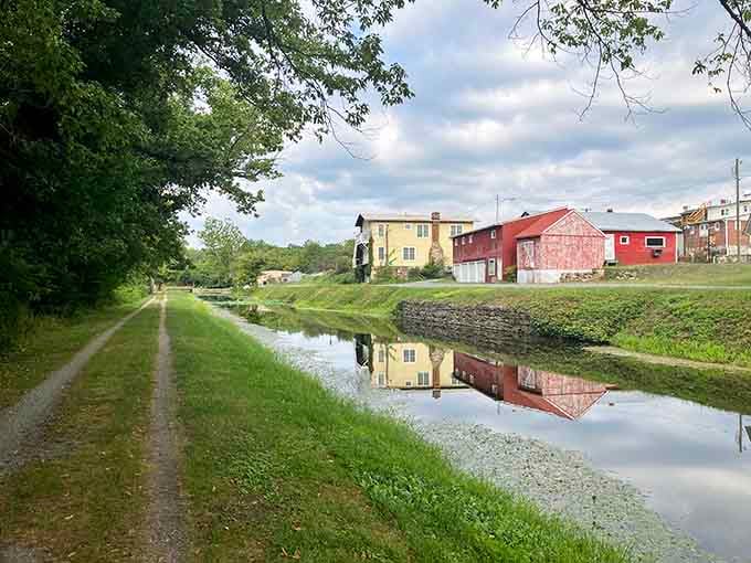 The towpath mirrors buildings perfectly, doubling the beauty and proving that sometimes the best views come from looking down.