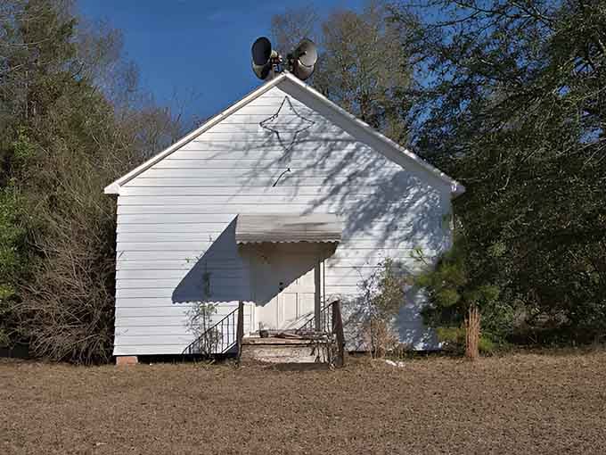 The white clapboard and cross detail speak to generations of faith, fellowship, and Sunday morning gatherings.