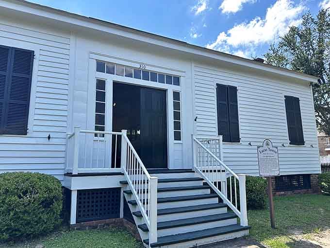 Crisp white railings and black shutters create the kind of contrast that makes historic preservation absolutely sing with character.