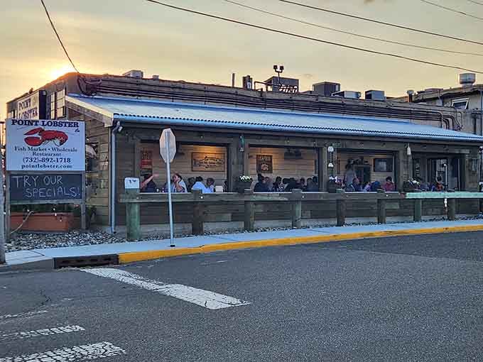 Golden sunset light bathes the outdoor deck where diners enjoy fresh catches as the day melts into a perfect evening.