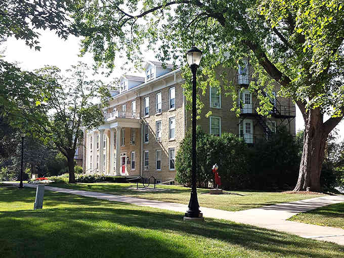Stately buildings frame a tree-shaded campus where knowledge and tradition meet under branches that have witnessed decades of learning and growth.