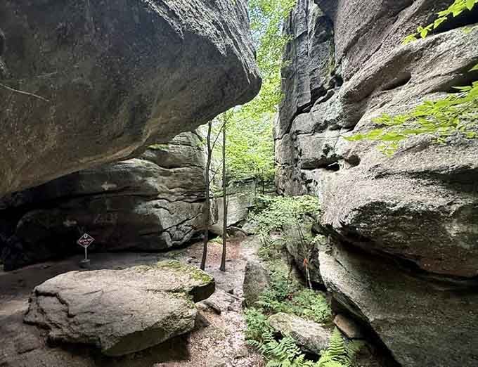 Massive rock formations tower overhead, creating natural corridors that feel like walking through stone cathedrals.