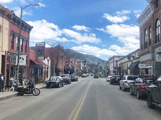Mountains rise majestically behind this charming main street where outdoor adventure meets artistic spirit in perfect Colorado harmony.