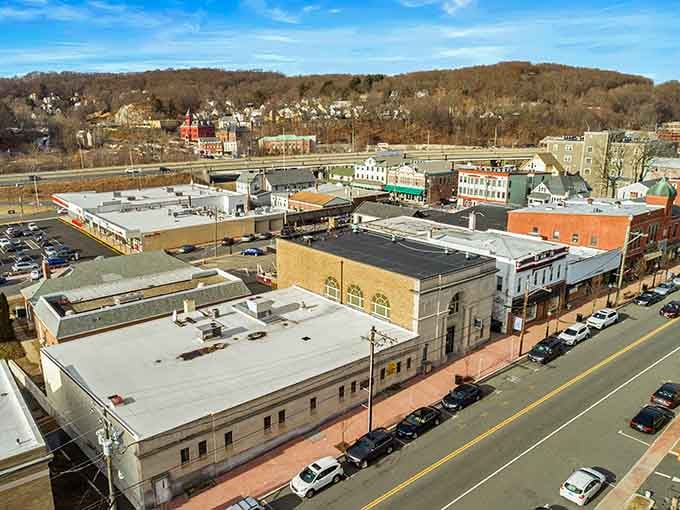 An incredible bird's-eye view captures the scenic layout and bustling life of downtown Shelton on a beautiful sunny day.