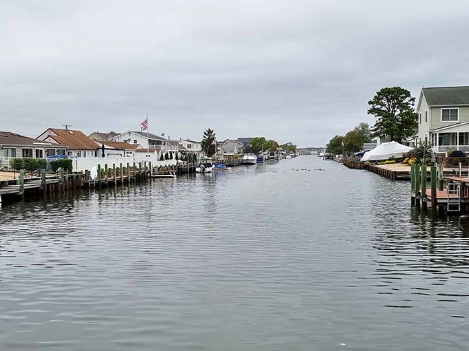 Another view down the peaceful canal reveals docks and decks where residents enjoy morning coffee watching boats pass.