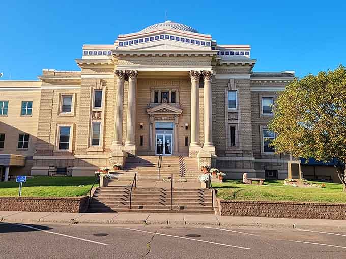 The courthouse commands attention with classical columns that remind us democracy starts in these small-town centers of civic life.