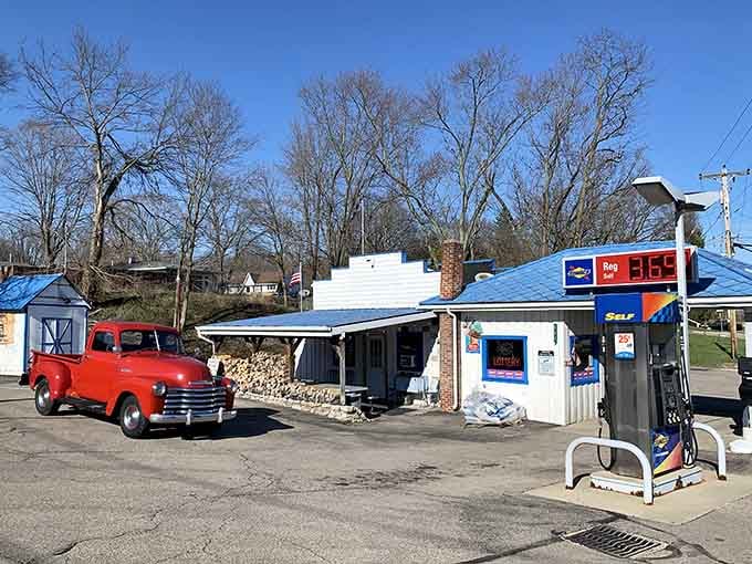 A vintage red truck parked at this classic gas station creates a scene straight from American Graffiti's glory days.