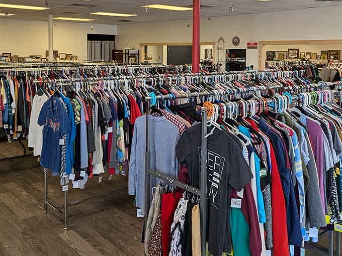 Rows and rows of clothing await your discovery at Beyond the Thrift, where every rack holds potential treasures for savvy shoppers.