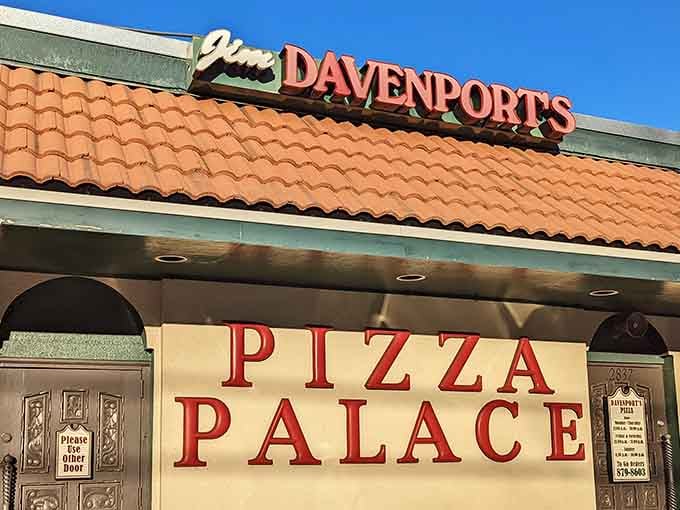 That terra-cotta roof and bold signage promise the kind of neighborhood pizza joint where memories are made daily.