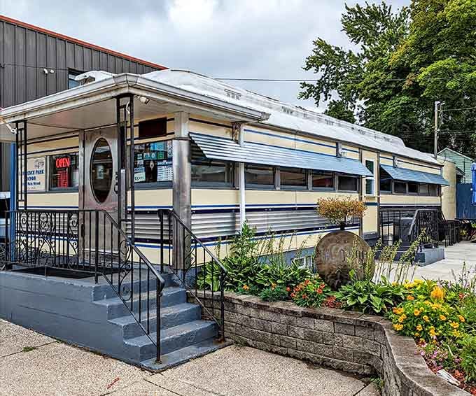 That gleaming stainless steel exterior and flower-lined entrance prove breakfast dreams really do come with their own welcome committee.