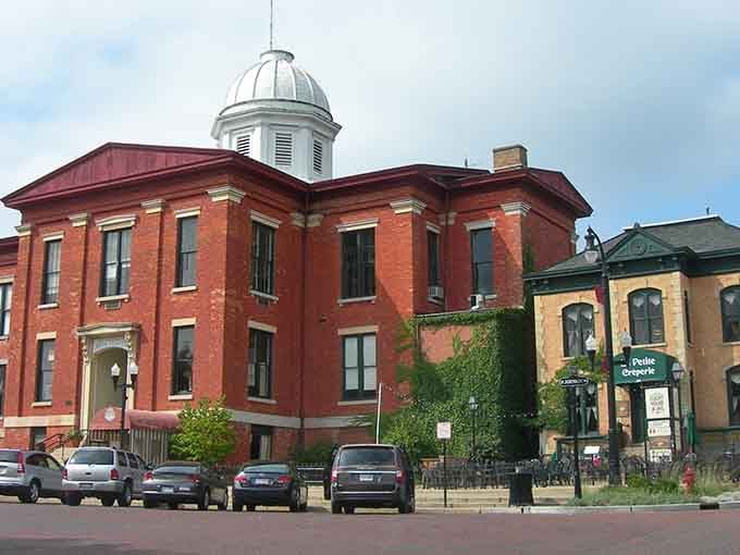 Historic red brick buildings and a charming creperie invite you to enjoy a peaceful afternoon stroll through this scenic square.