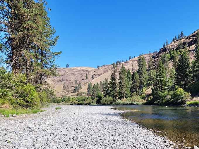 The gravel riverbank stretches out like nature's welcome mat, inviting you to kick off your shoes and stay awhile.