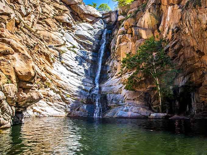 This is what happens when Mother Nature decides to show off—80 feet of pure waterfall perfection cascading into paradise.