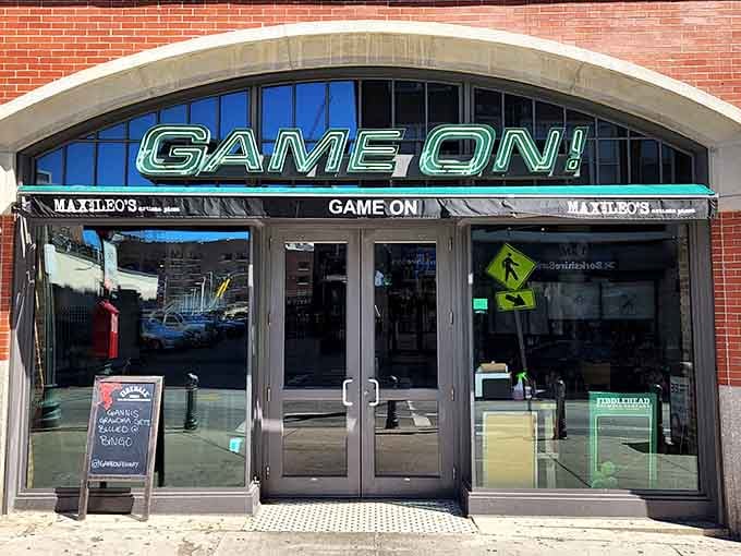 The inviting entrance to Game On! welcomes sports fans with its bright neon signage and prime location near Fenway Park.