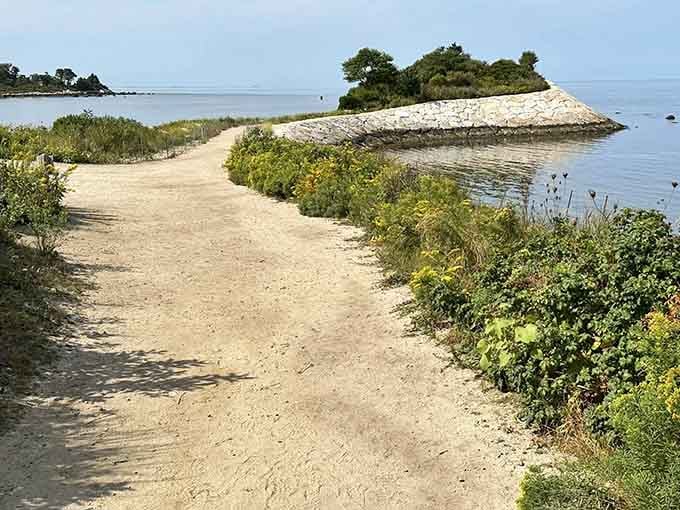 Discover breathtaking coastal views as you follow this unique stone-lined path toward the lush, green overlook of the harbor.