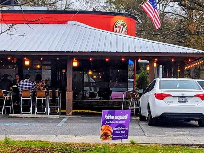 String lights glow above the patio where diners gather, drawn by burgers that have achieved legendary status in Columbia.
