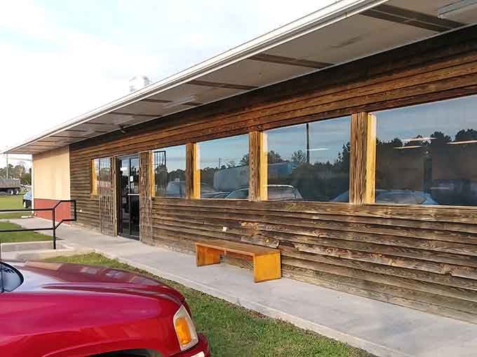 The wooden exterior and simple benches outside give you zero hints about the feast waiting just beyond that entrance.
