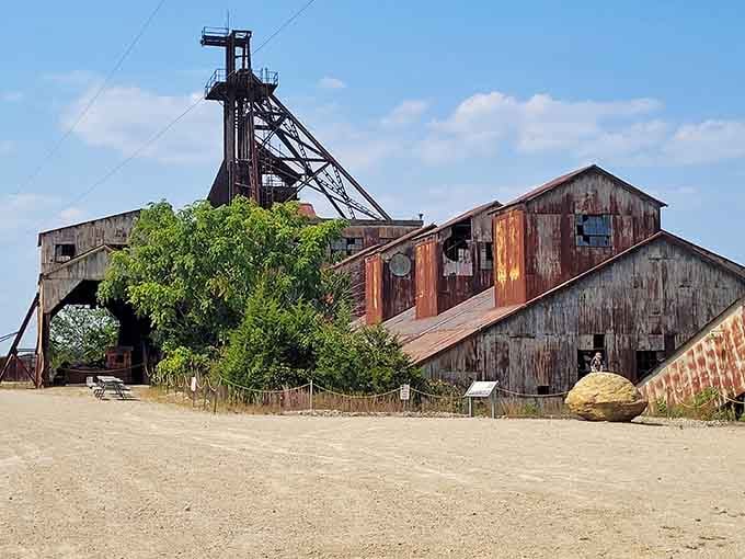 The towering headframe and weathered mill buildings showcase the impressive scale of Missouri's historic lead mining operations in Park Hills