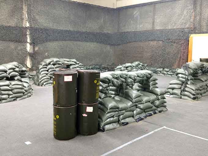 Strategic sandbag bunkers and barrel obstacles create the perfect battlefield setup for epic foam dart showdowns at The Tag Zone in Bremerton.
