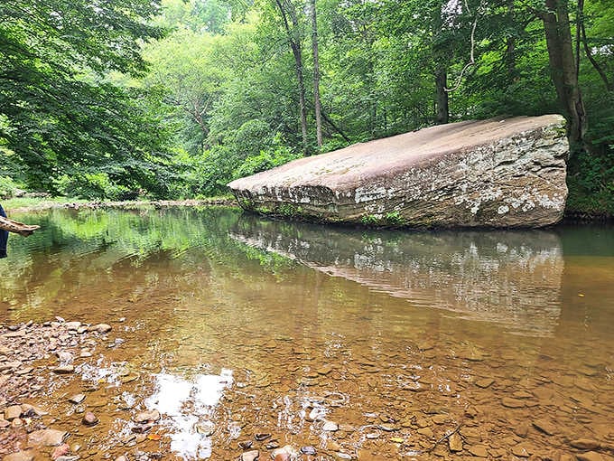 That massive boulder balanced over crystal-clear water isn't a movie set, it's your new favorite swimming spot.