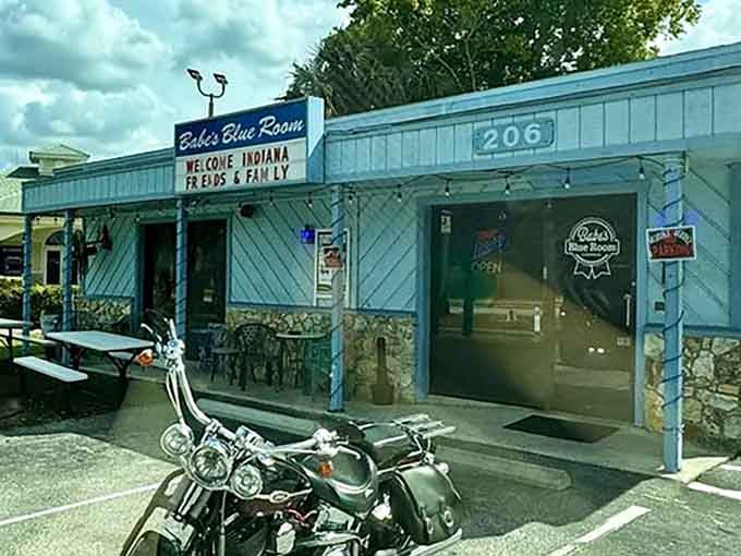 The welcoming marquee and outdoor seating prove that paradise sometimes comes with picnic tables and a motorcycle in the foreground.