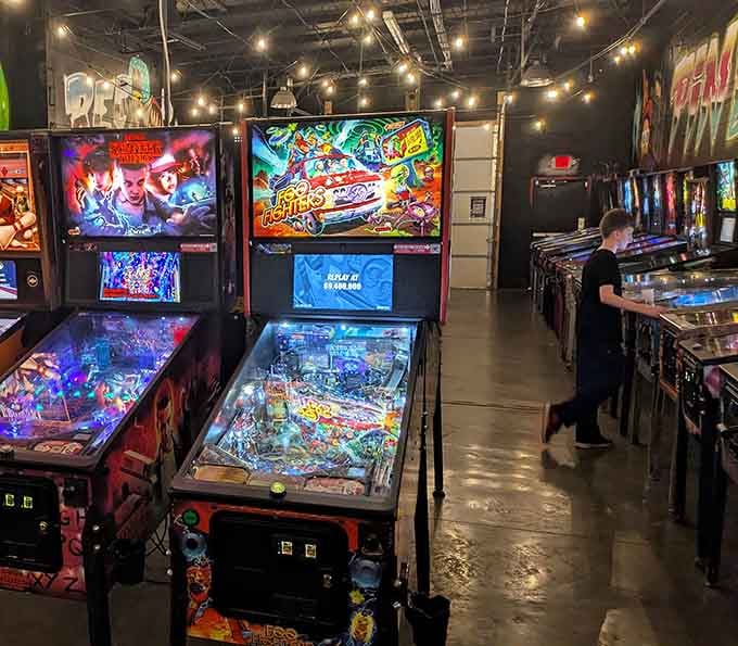 Rows of gleaming arcade machines stand ready like soldiers of fun, waiting to devour your afternoon and loving every minute.