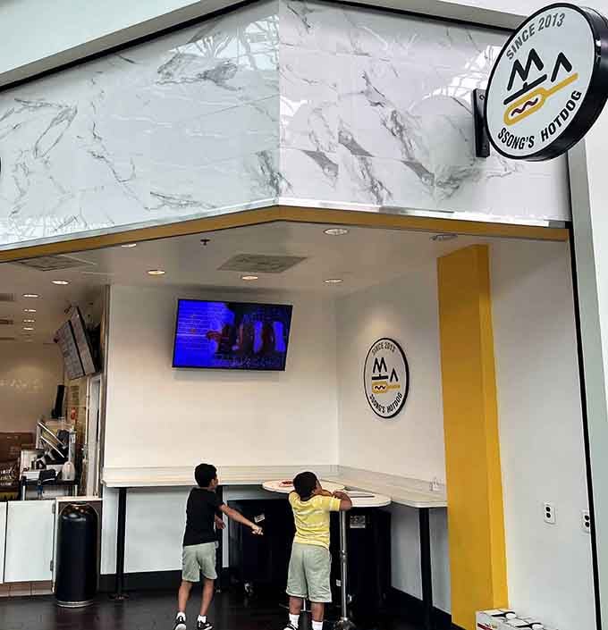 That cheerful yellow checkerboard pattern isn't just decoration&mdash;it's practically radiating the joy you're about to experience at Ssong's Hotdog.
