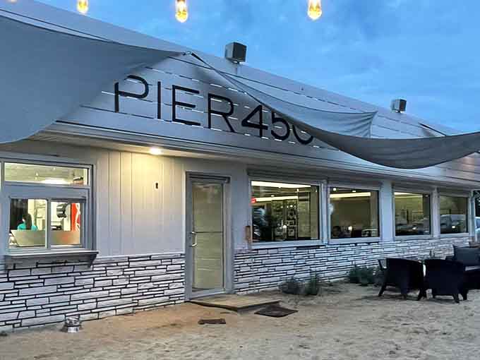 Evening lights illuminate the entrance to waterfront bliss, proving that good design and great food make perfect neighbors.