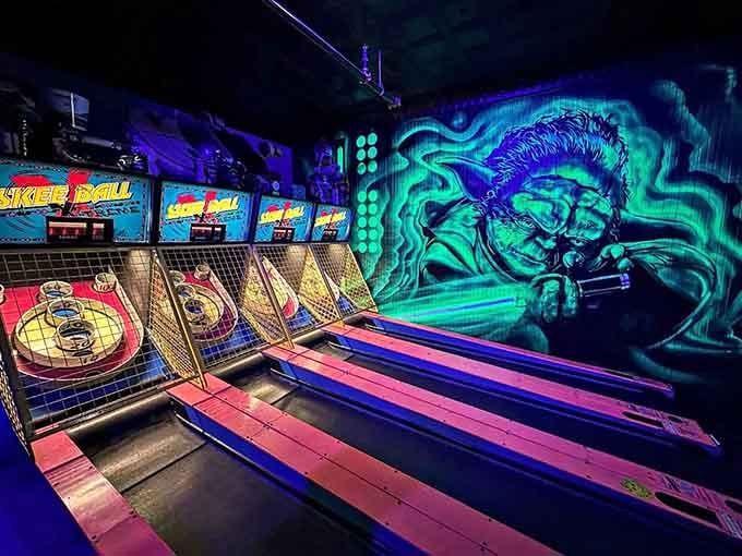 Skee-Ball lanes line up under neon lights and stunning wall art, offering that perfect combination of competitive fun and retro arcade vibes.