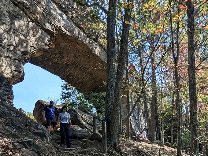Standing beneath tons of ancient sandstone while hikers explore above – nature's cathedral has the best architecture.