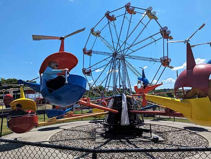 The colorful chaos of classic amusement park rides proves that happiness doesn't require a billion-dollar budget.
